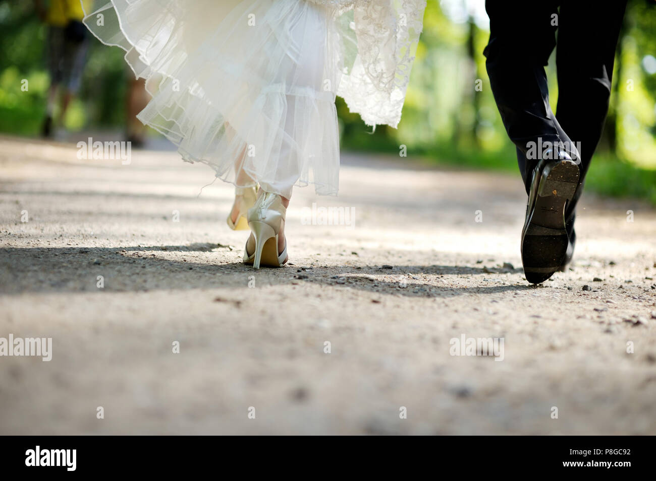 Bride and groom legs walking away Stock Photo - Alamy
