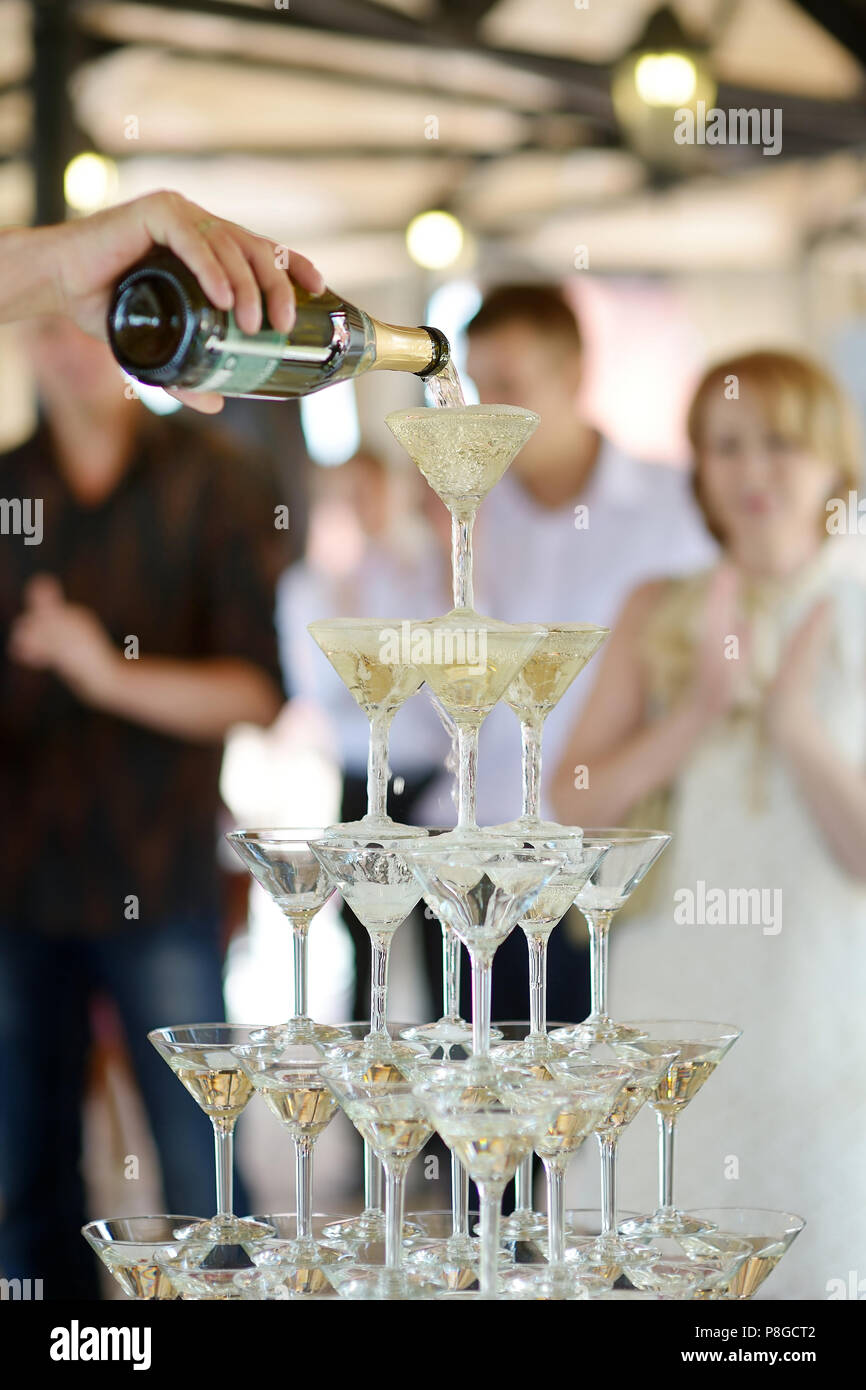 Pouring champagne into fancy glasses Stock Photo - Alamy