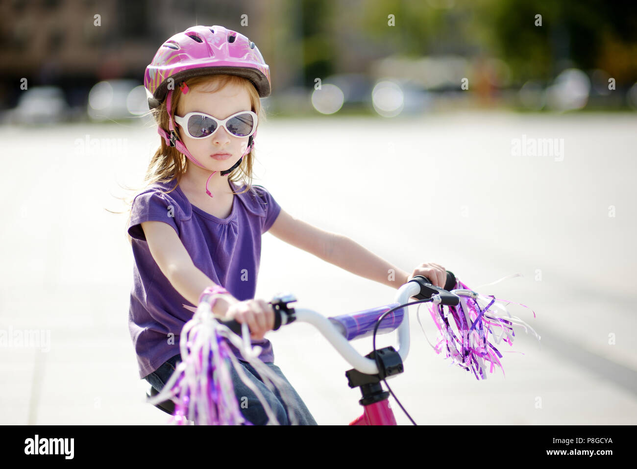 Adorable girl riding a bike on beautiful summer day Stock Photo - Alamy