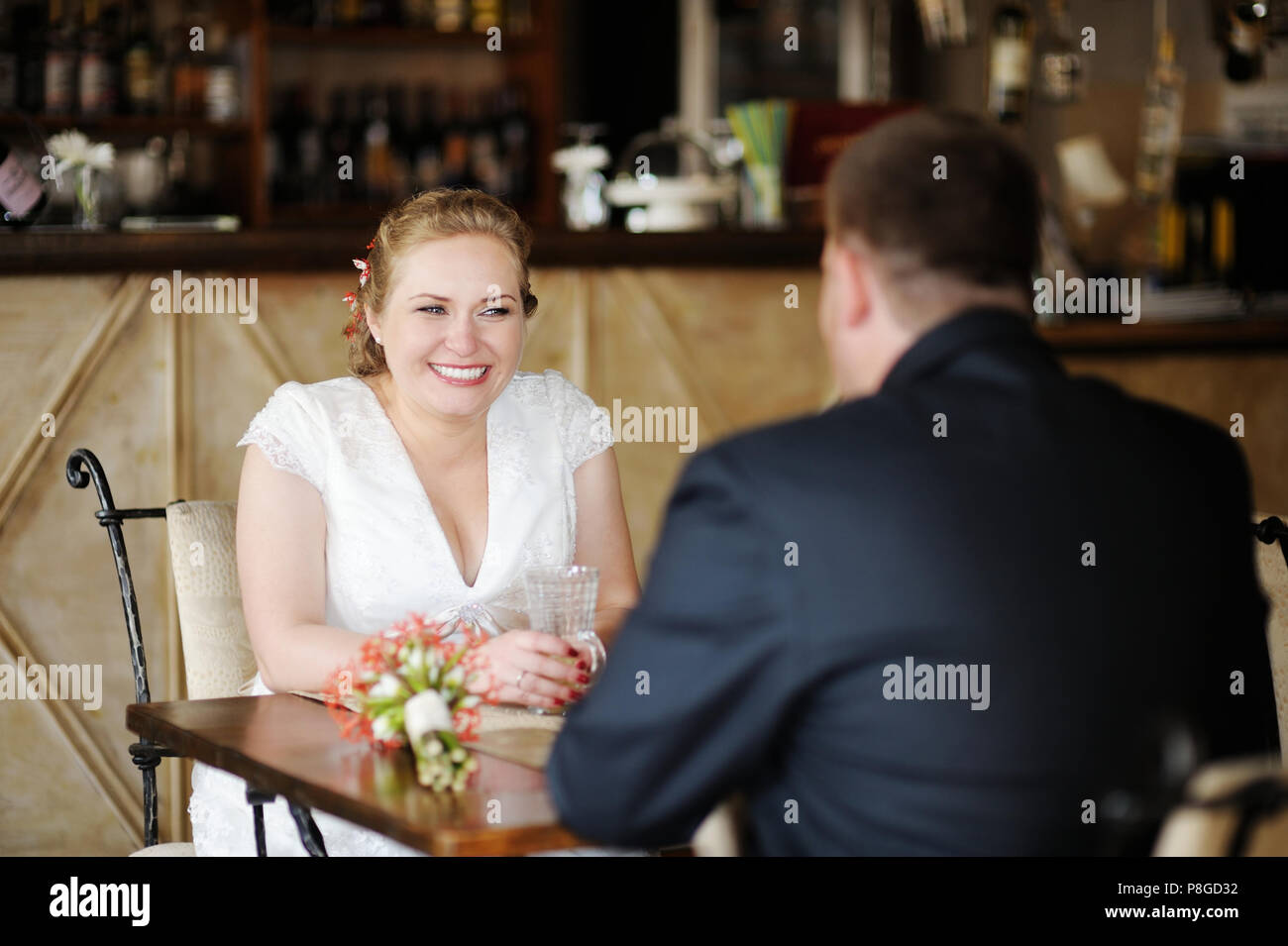 Bride and groom drinking coffee at a cafe Stock Photo - Alamy