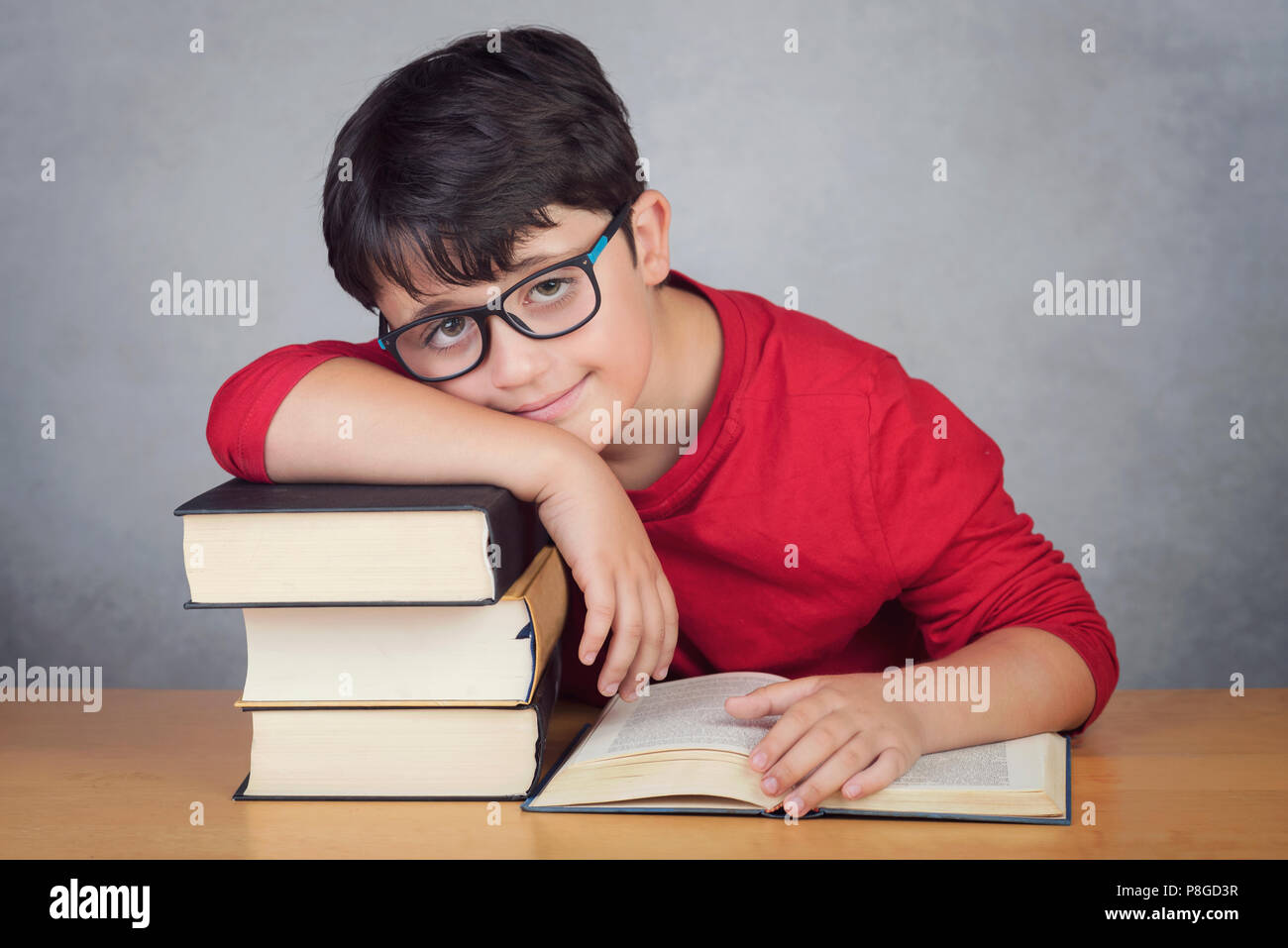 Boy leaning on books hi-res stock photography and images - Alamy
