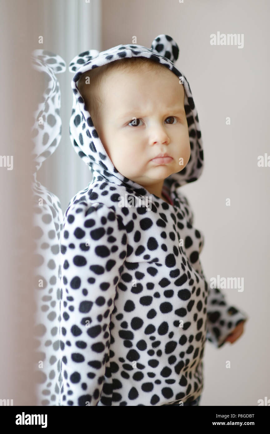Adorable little girl in spotty hoody by the window Stock Photo - Alamy