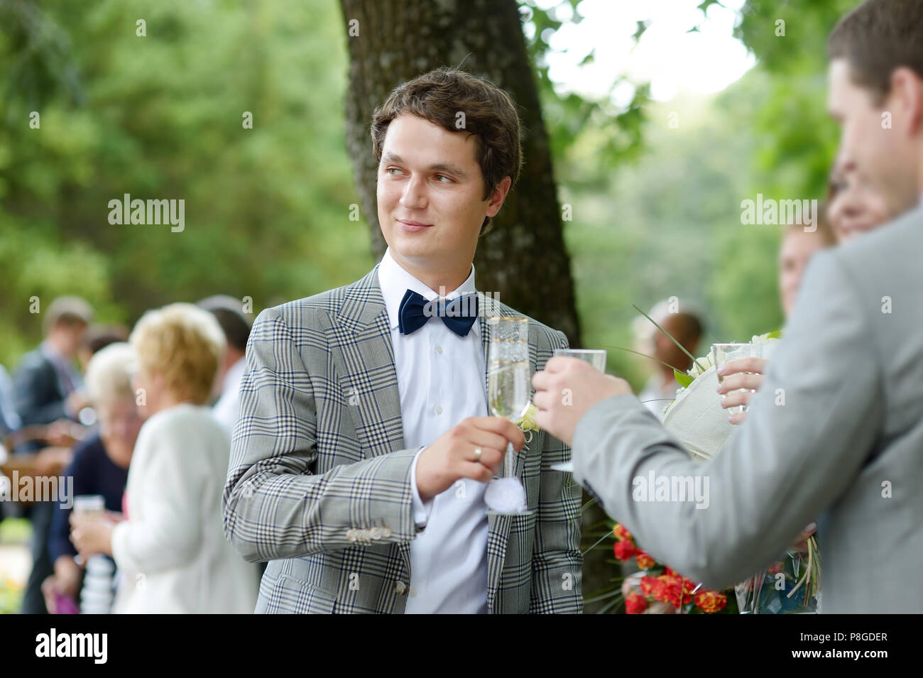 Wedding guests toasting happy bride and groom Stock Photo - Alamy