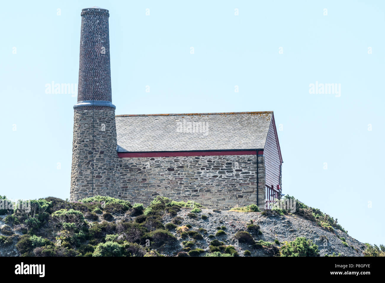Building and chimney of a tin mine on the top of a hill at the village ...
