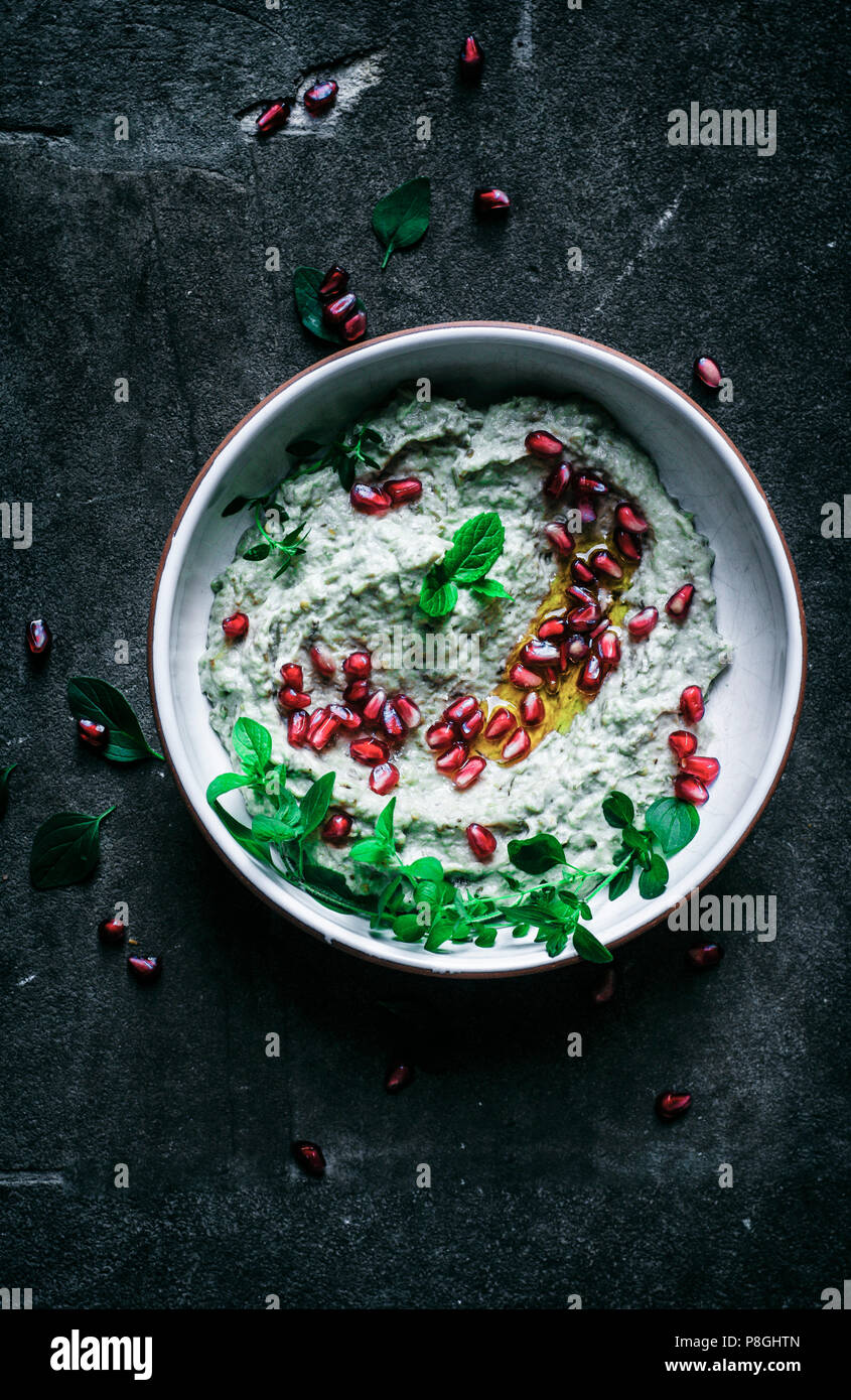 Baba Ghanoush with herbs, olive oil, and pomegranate Stock Photo - Alamy