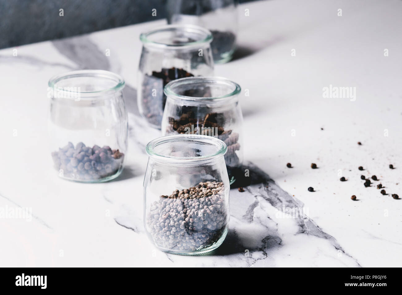 Variety of different black peppers allspice, pimento, long pepper ...