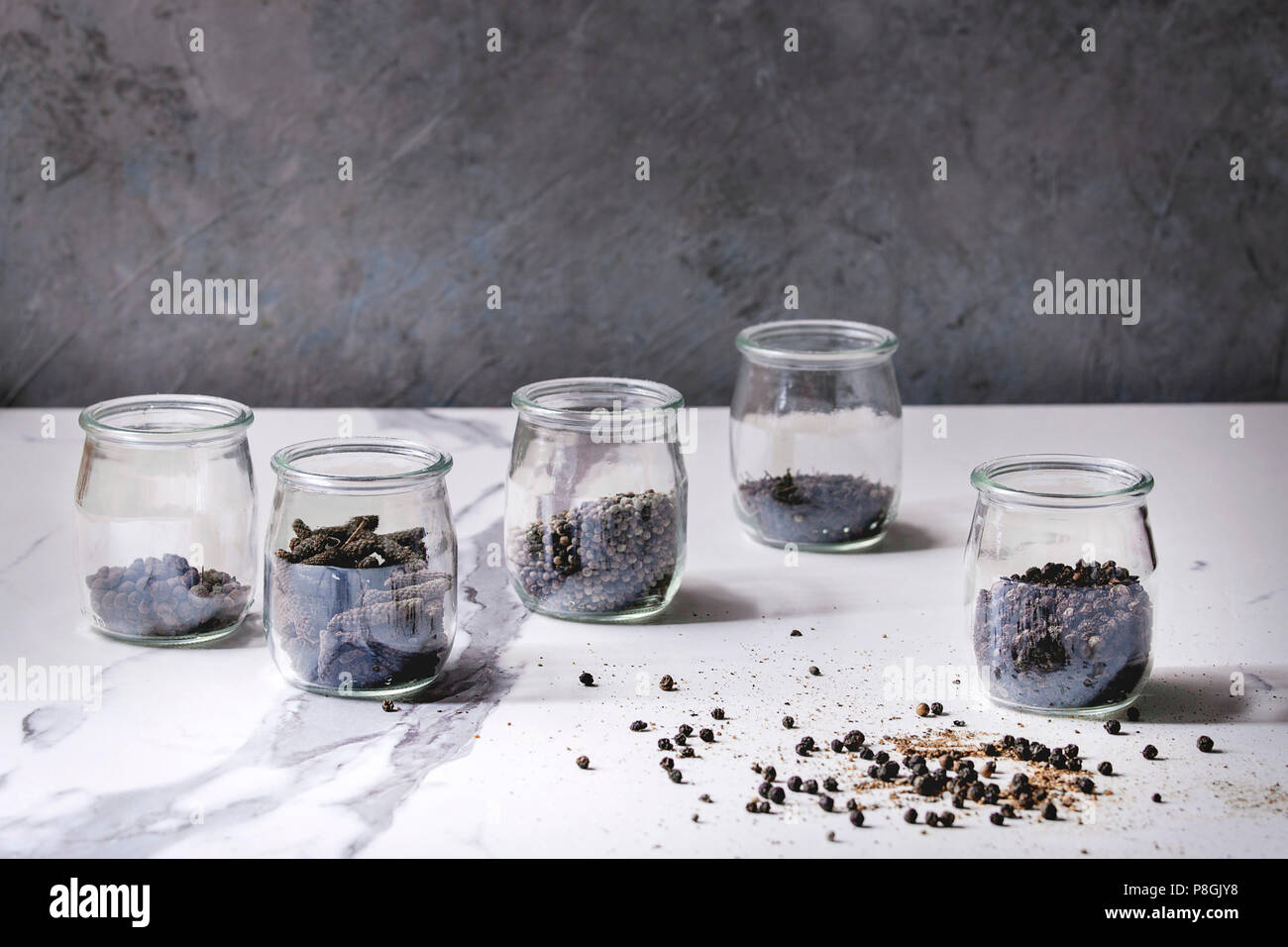 Variety of different black peppers allspice, pimento, long pepper ...