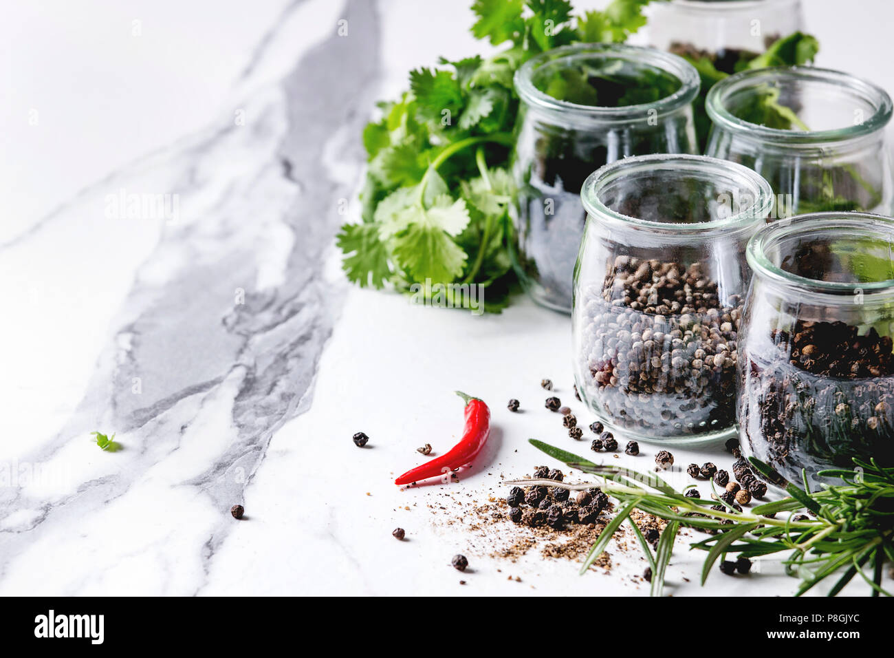 Variety of different black peppers allspice, pimento, long pepper ...