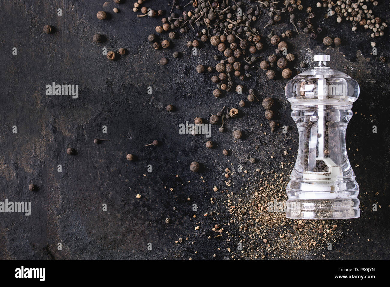 Variety of different black peppers allspice, pimento, long pepper ...