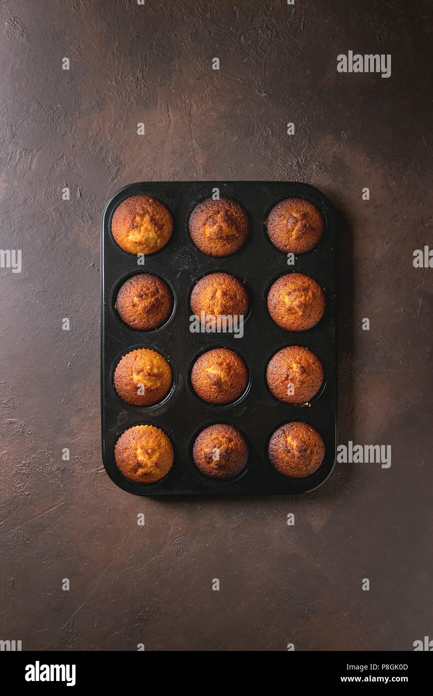 Fresh baked homemade lemon cakes muffins in black teflon baking dish ...