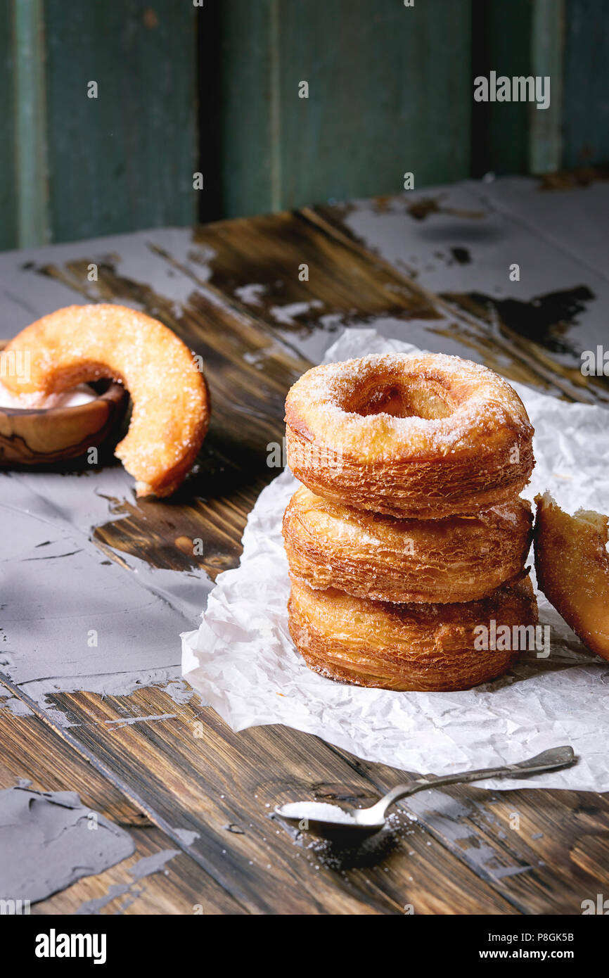Homemade puff pastry deep fried donuts or cronuts in stack with sugar ...