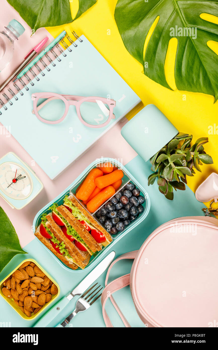 Creative flat lay with healthy lunch and office or school supplies on ...