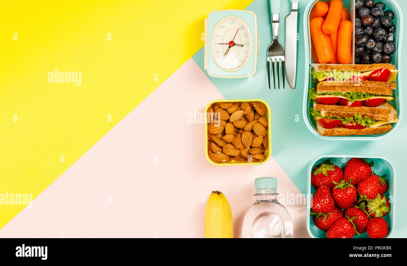 Creative flat lay with healthy lunch and office or school supplies on ...