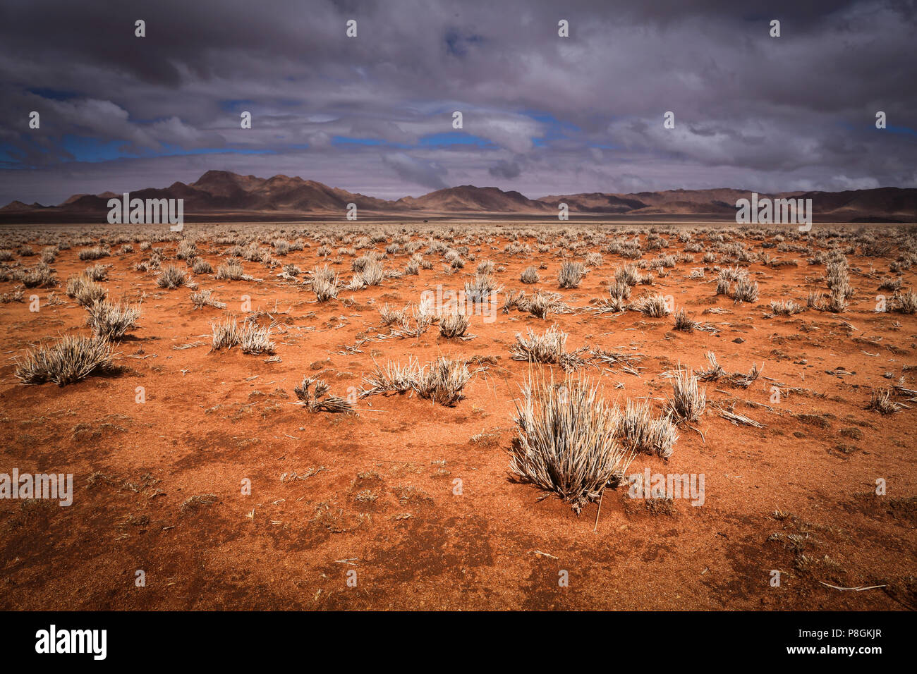Dry landscape with clouds and mountains in the desert of Namibia Stock ...