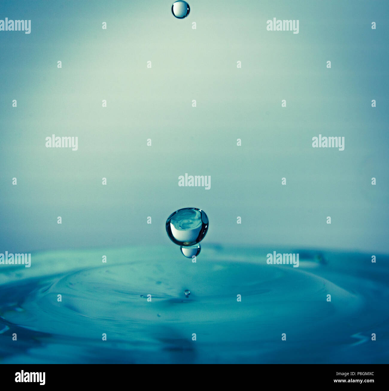 Macro shots of water droplets in motion captured mid-air and on surface ...