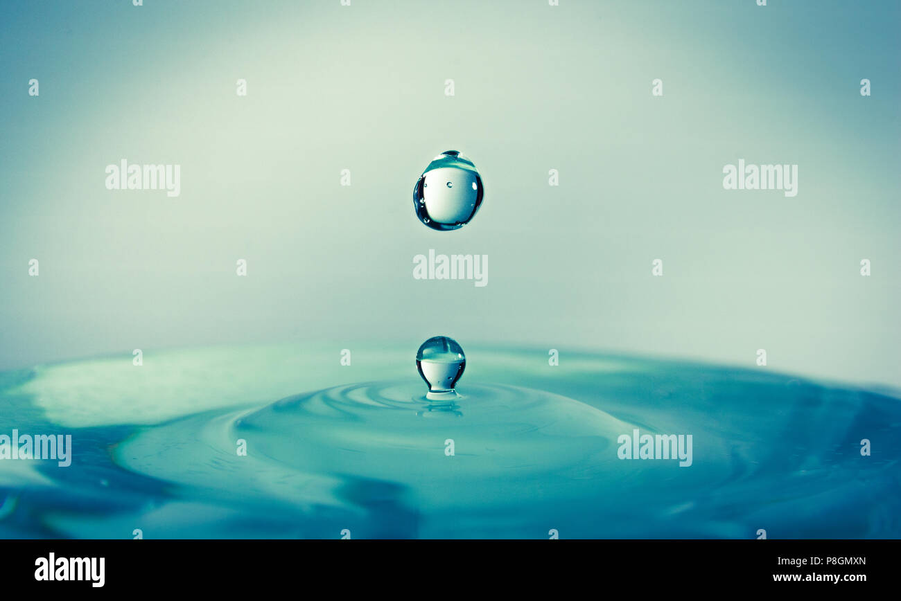 Macro shots of water droplets in motion captured mid-air and on surface ...