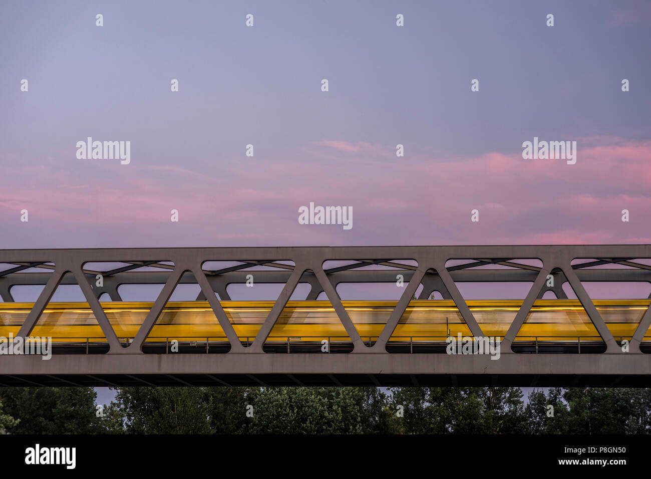A passenger train on the U2 metro line crosses a bridge between the ...