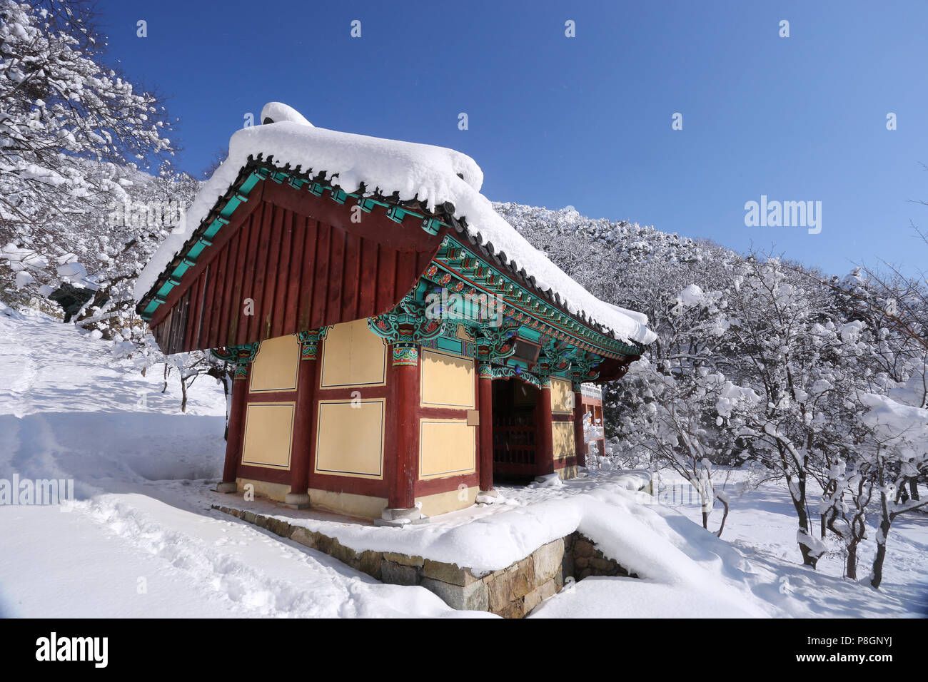 Snow covered Buddhist temple on a clear winter day in the mountains of ...