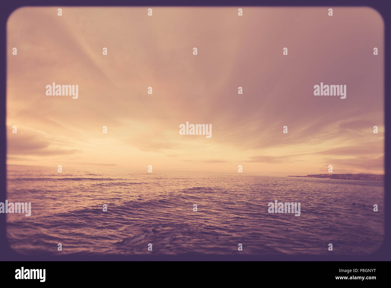 Idyllic ocean at sunset with sea, sky and sun in soft tones Stock Photo ...