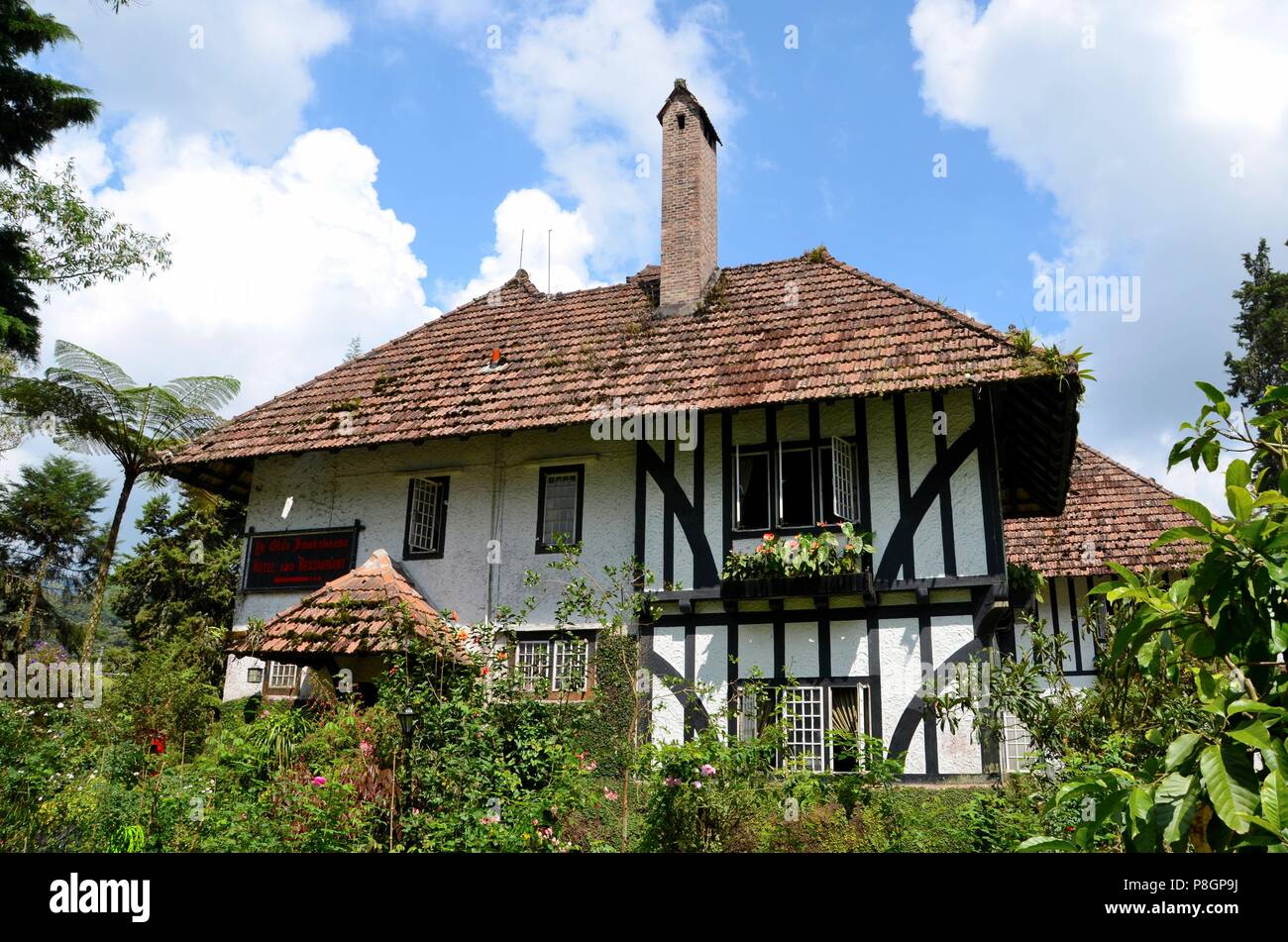 Gardens and English colonial Tudor bungalow cottage now boutique hotel ...