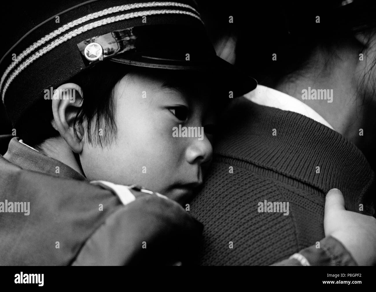 Chinese BOY naps while being held by his mother on the streets of ...