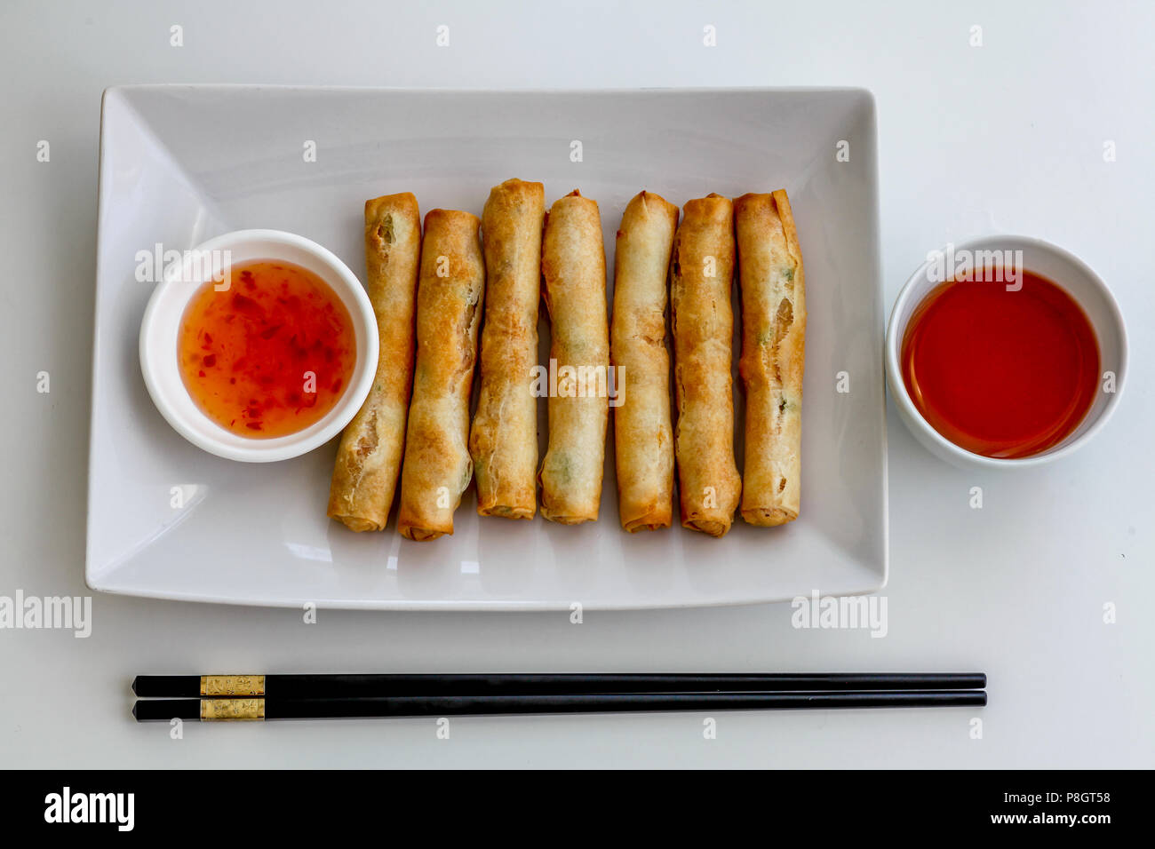 Spring Rolls served with dipping sauce and a cup of Chinese tea Stock ...