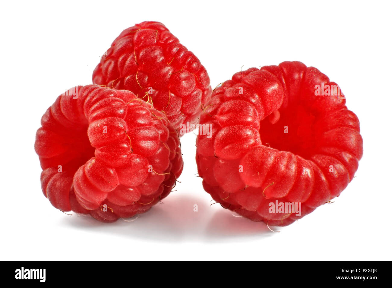 Three raspberries isolated on white background Stock Photo - Alamy
