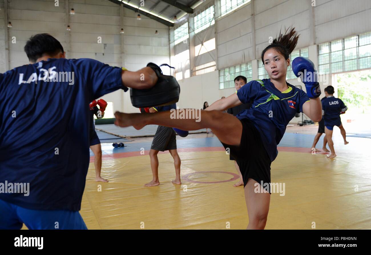 Vientiane, Laos. 10th July, 2018. Players of Laos national Wushu Sanda team exercise for the ...