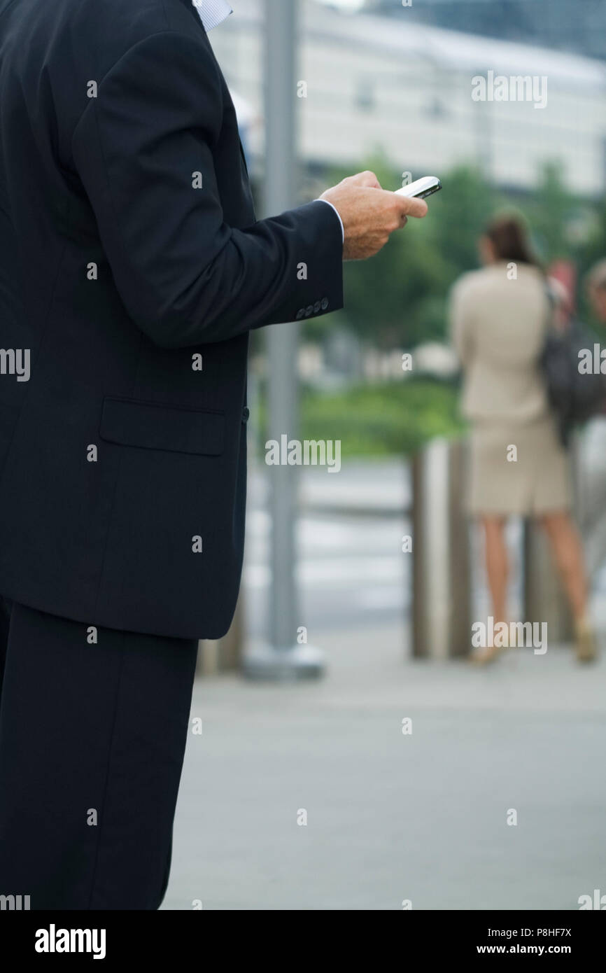 Business man checking his smartphone Stock Photo - Alamy