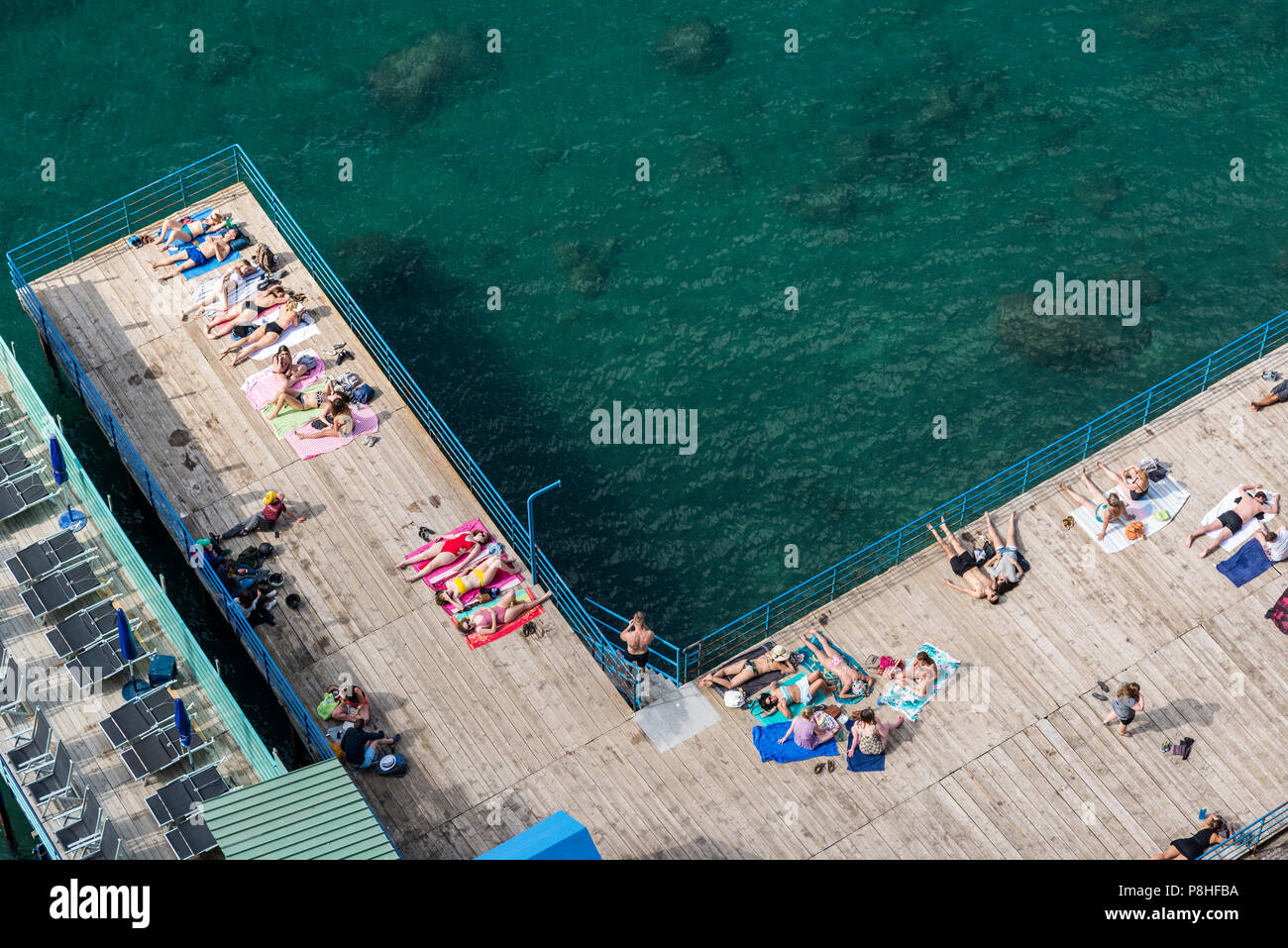 People sunbathing on bathing platform built out over the sea, Sorrento ...
