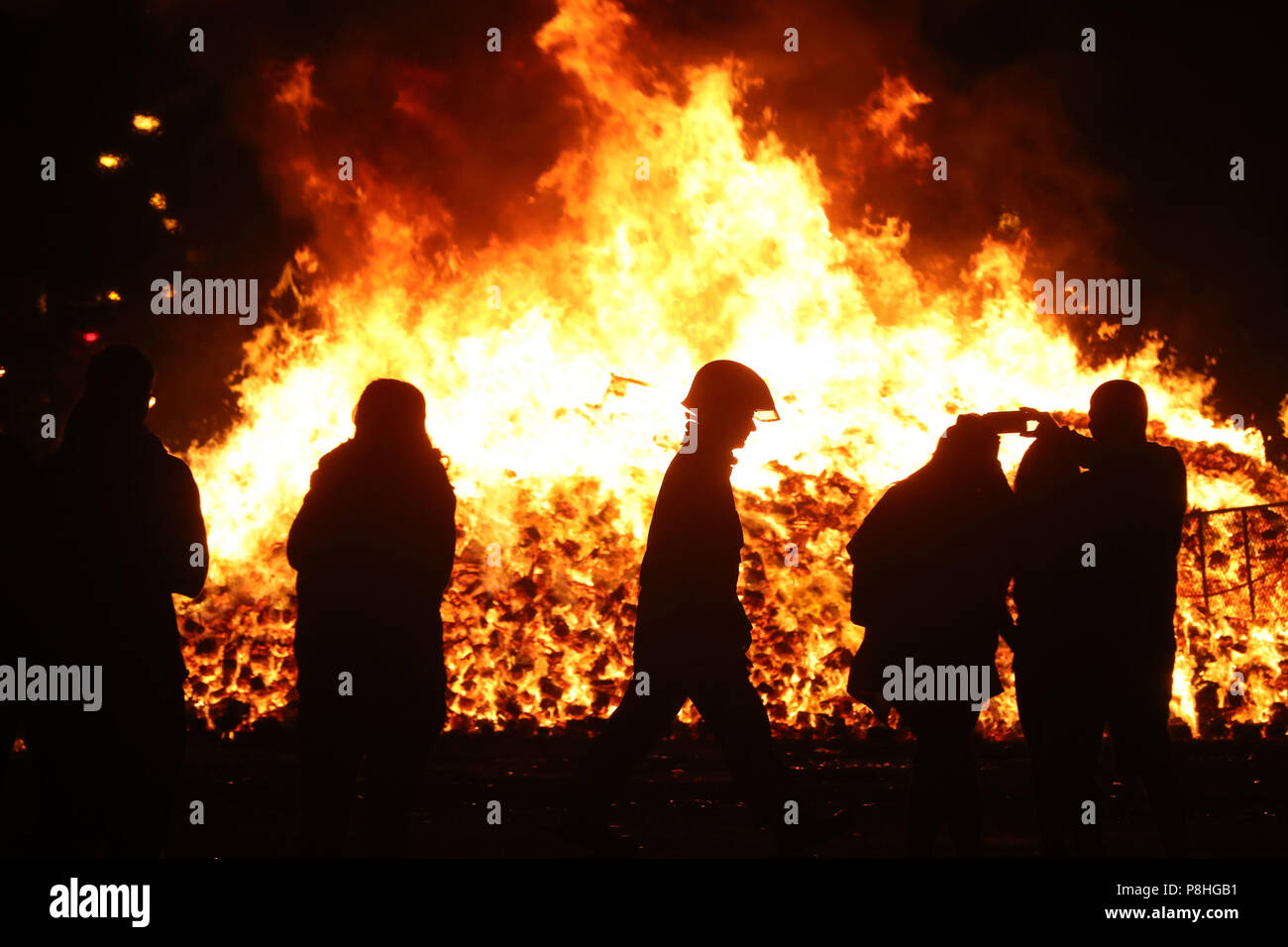 A firefighter attends to an 11th night Bonfire in the Sandy Row area of ...