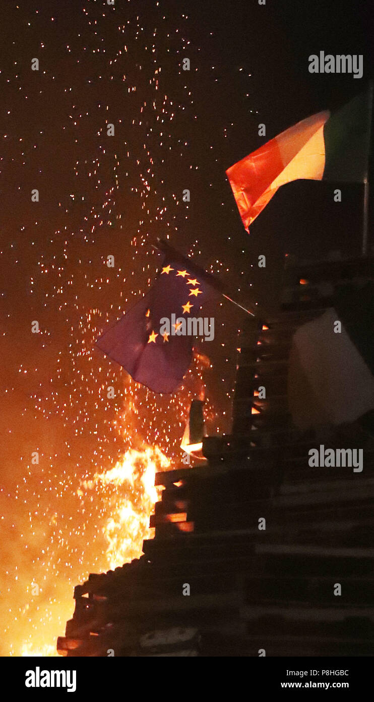 An EU flag is burned on an 11th night Bonfire in the Sandy Row area of ...