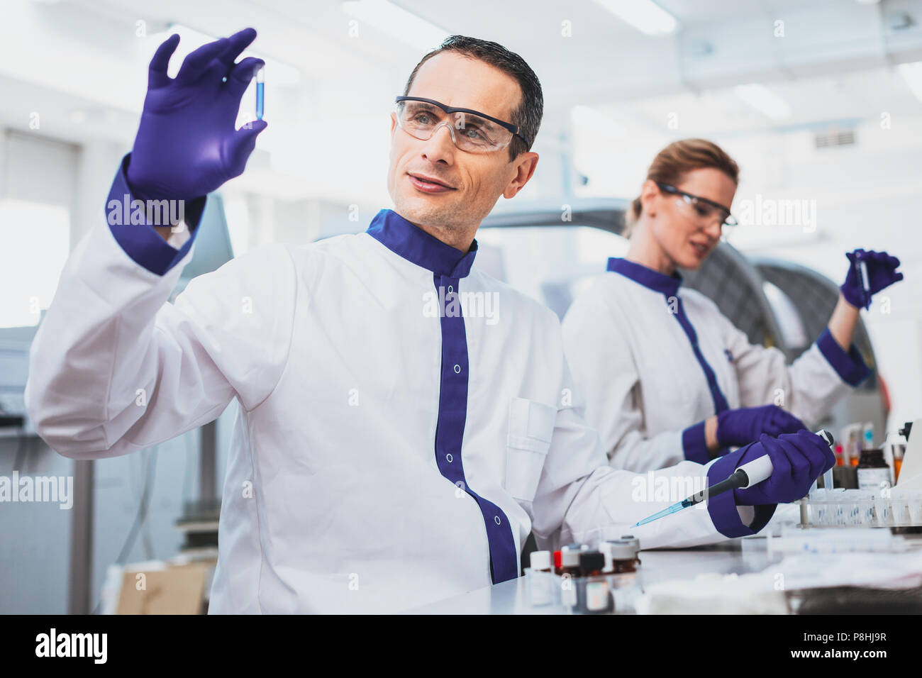 Cheerful professional scientists working hi-res stock photography and ...