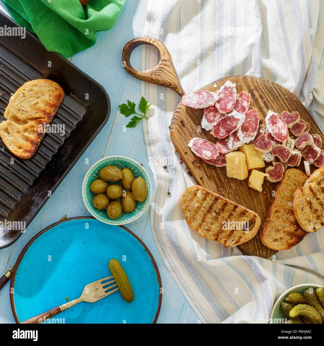 Lunch table concept. Top view Italian snacks Bruschetta on blue wooden ...