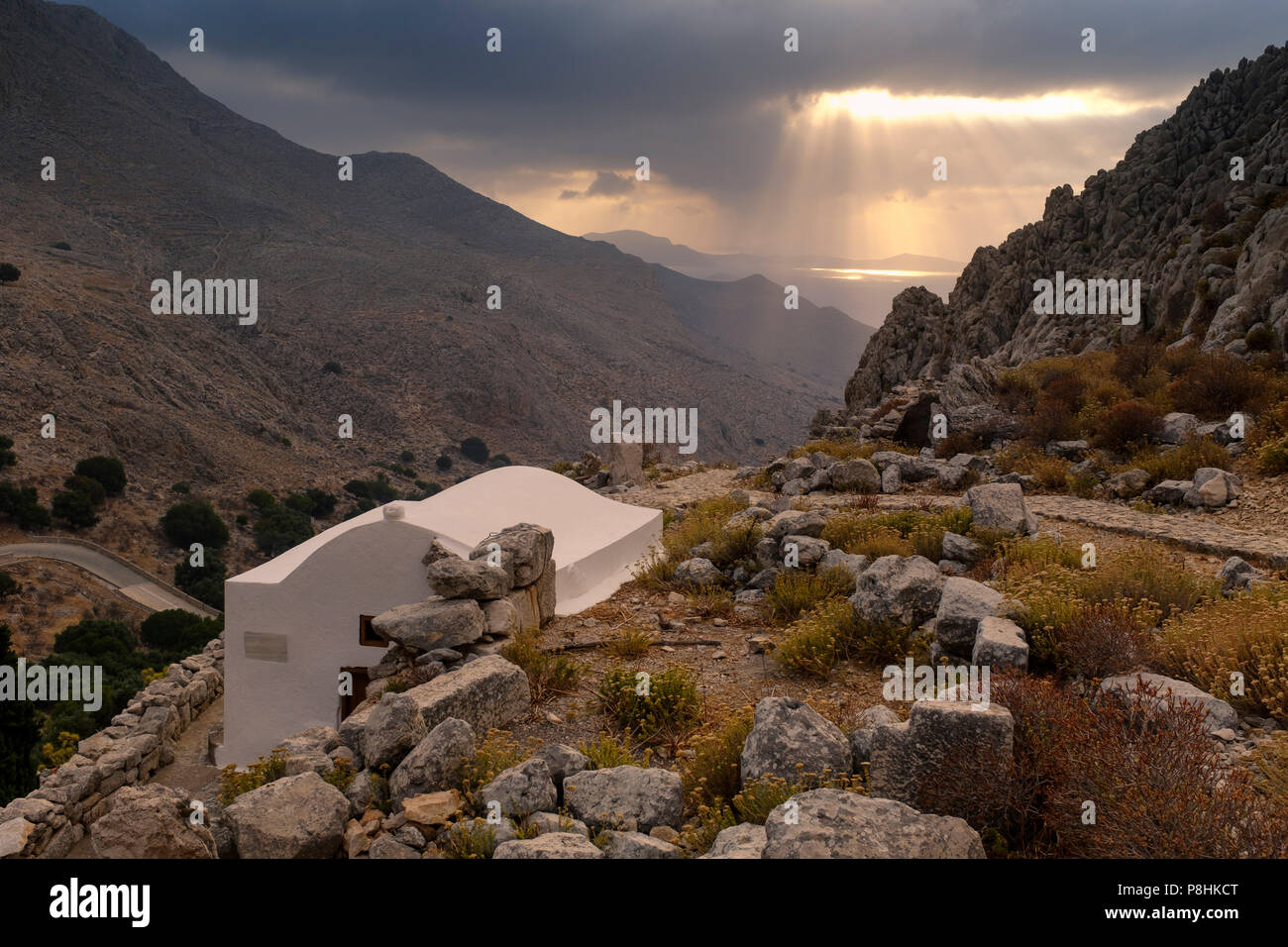 A small white chapel on the hill beneath the castle on Halki Stock ...