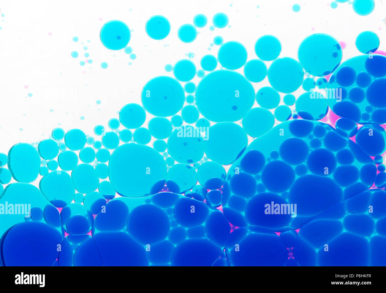Circles from a multi-coloured liquid Stock Photo - Alamy
