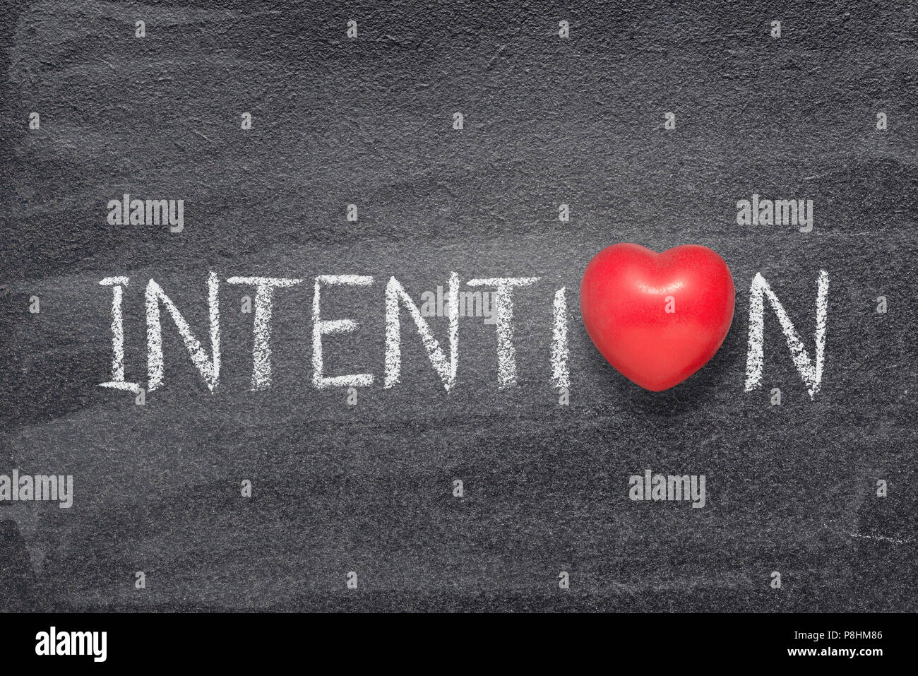 intention word handwritten on chalkboard with red heart symbol instead ...