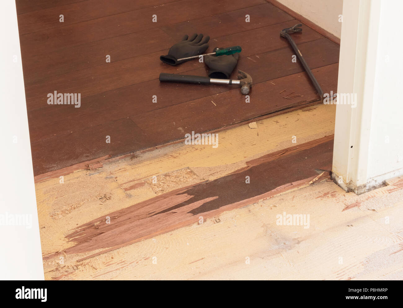 Breaking up a solid wooden floor in a house Stock Photo - Alamy