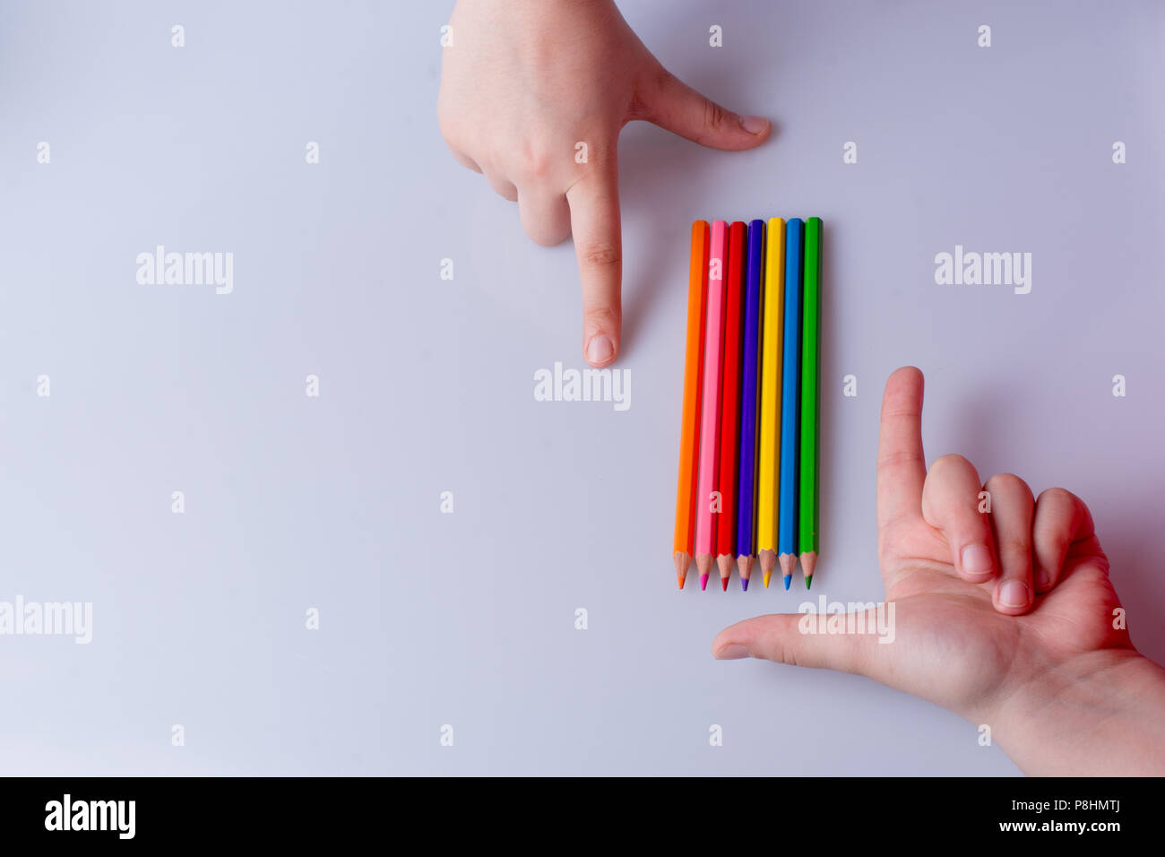 Hand holding color Pencils placed on a white background Stock Photo - Alamy