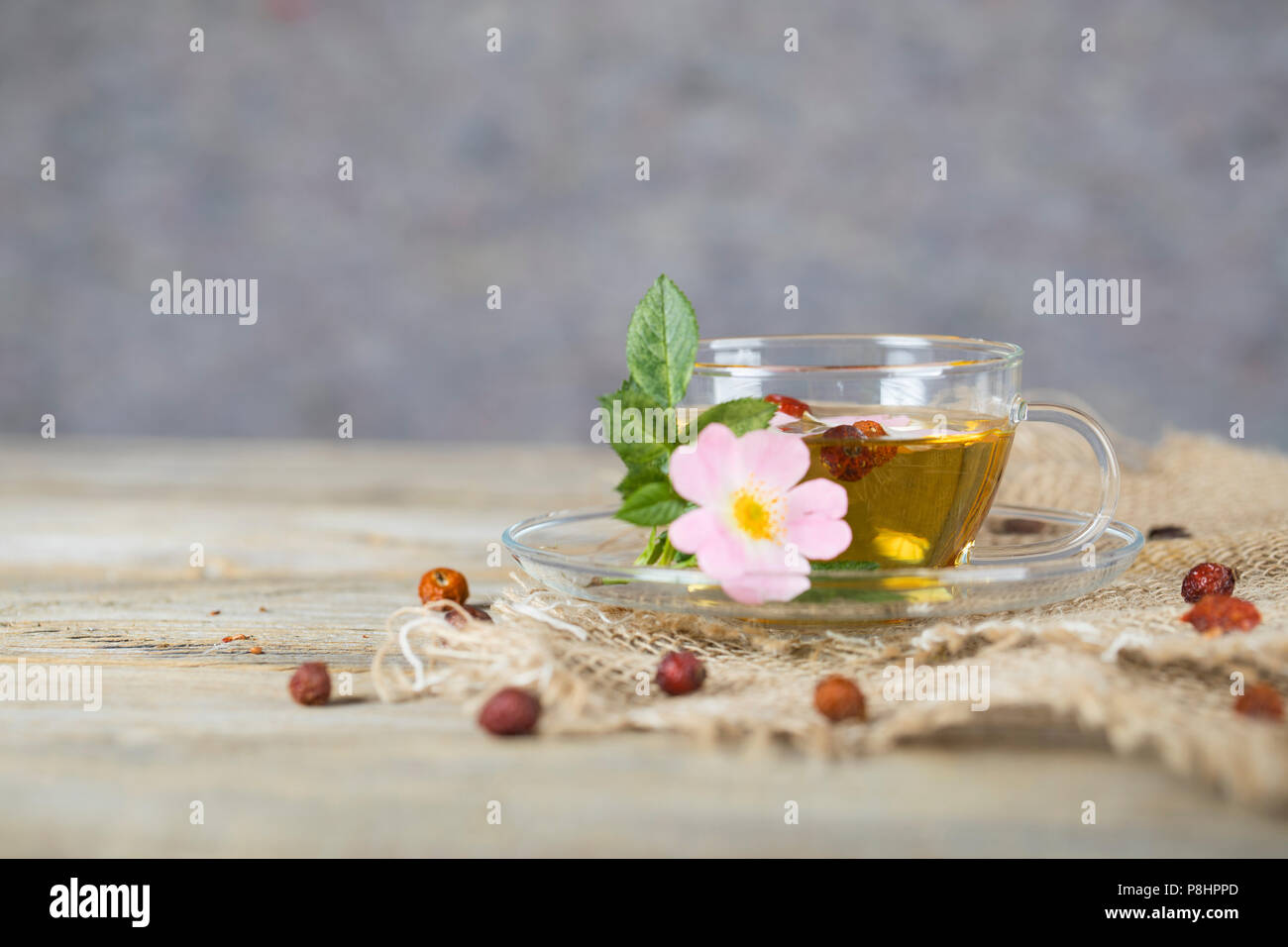 Rose hip herbal tea on a wooden surface. Free text. Closeup Stock Photo ...