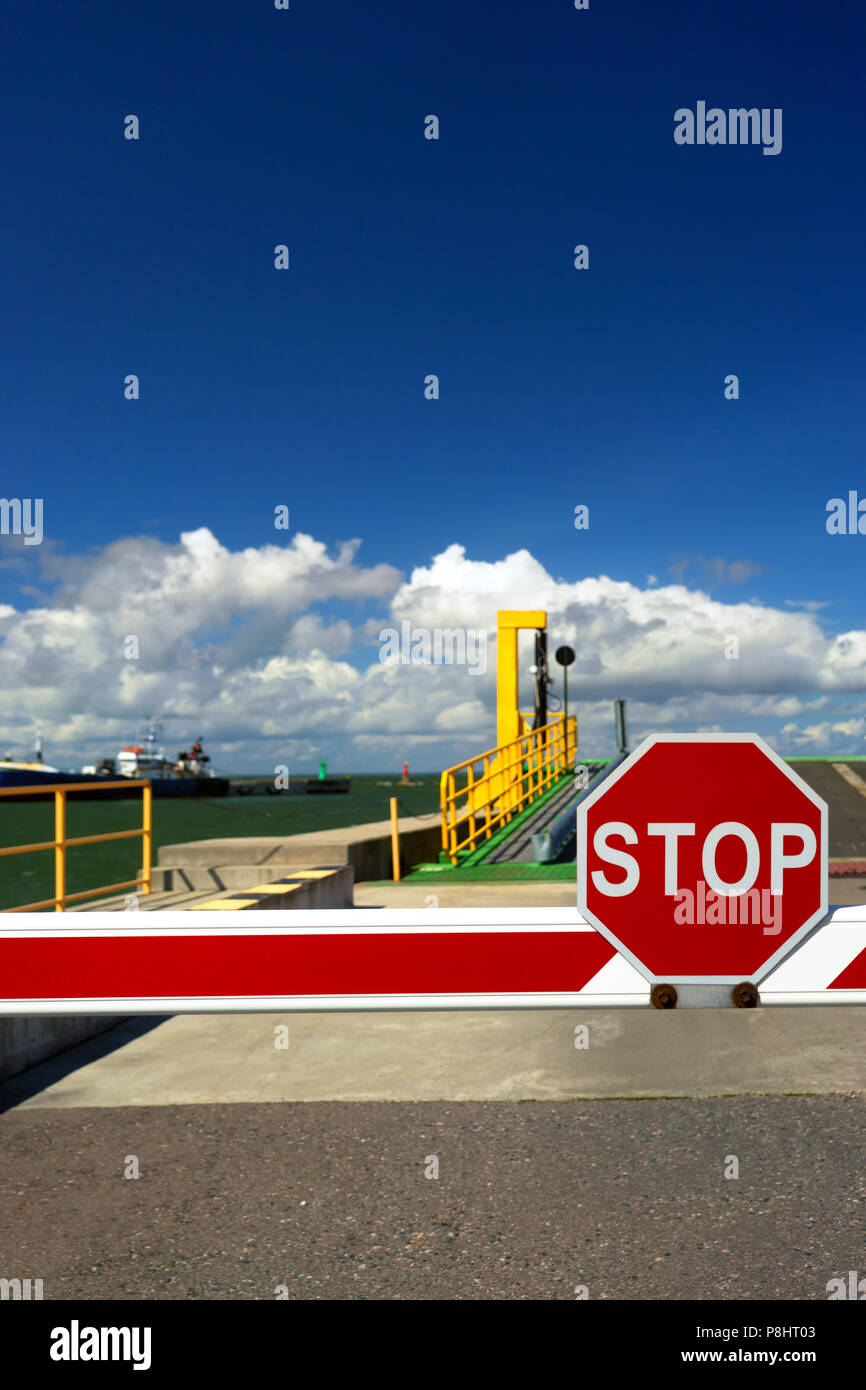 Stop sign on the road of loading on the ferry in the terminal of the ...