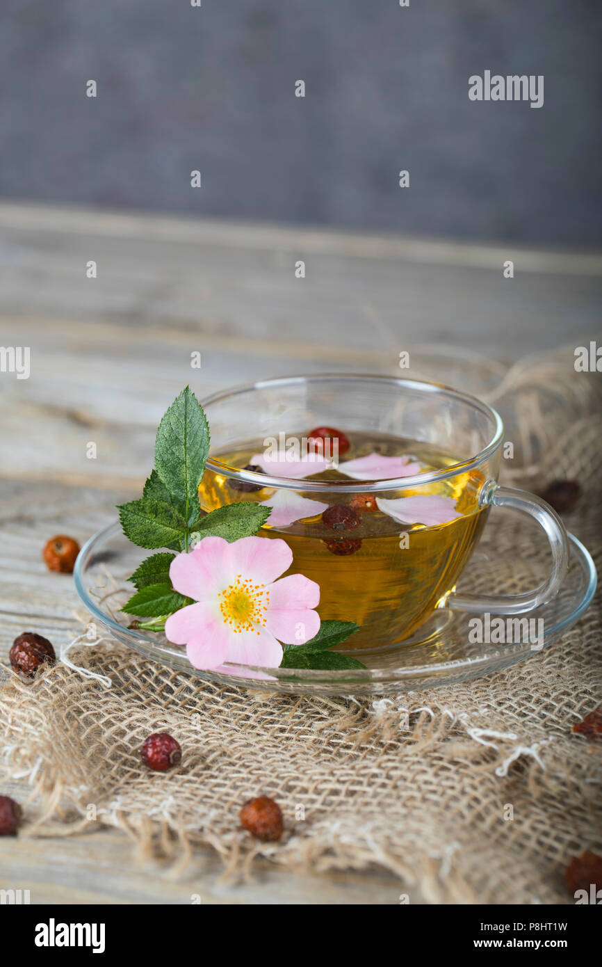 Rose hip herbal tea on a wooden surface. Free text. Closeup Stock Photo ...