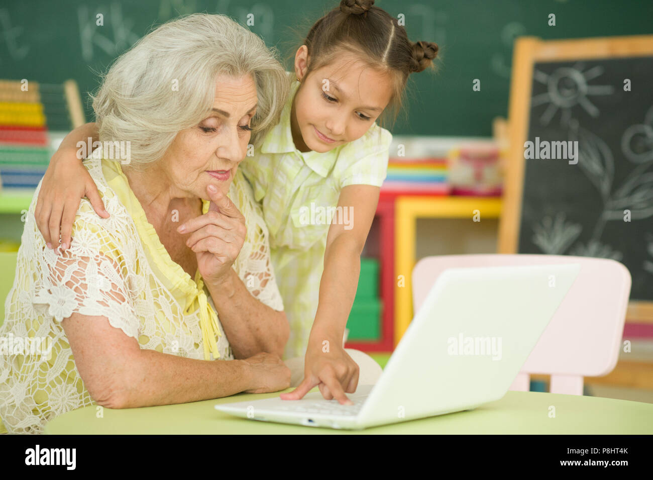 grandmother and daughter using modern laptop Stock Photo - Alamy