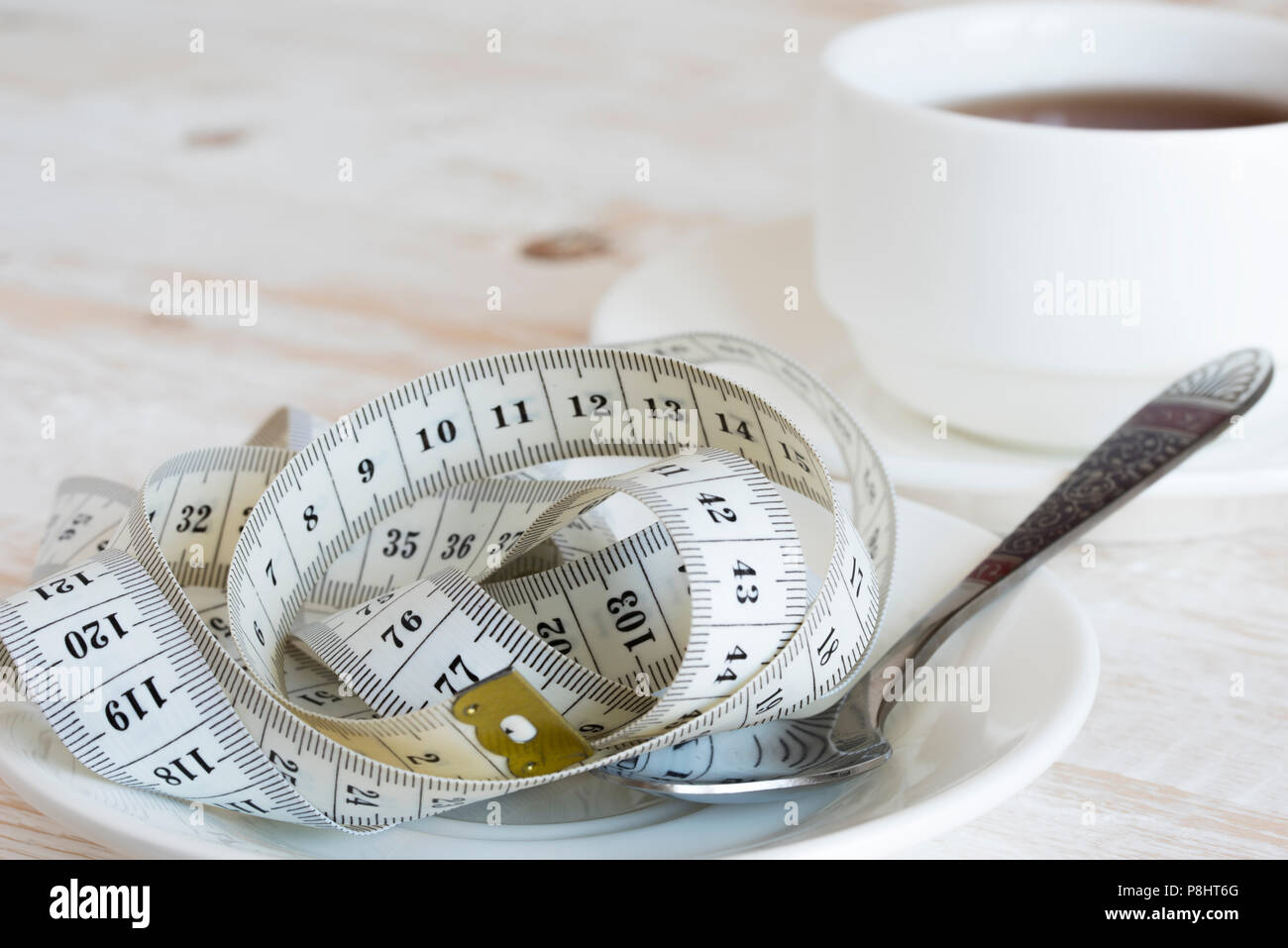 Diet food. Plate with measure tape Stock Photo - Alamy