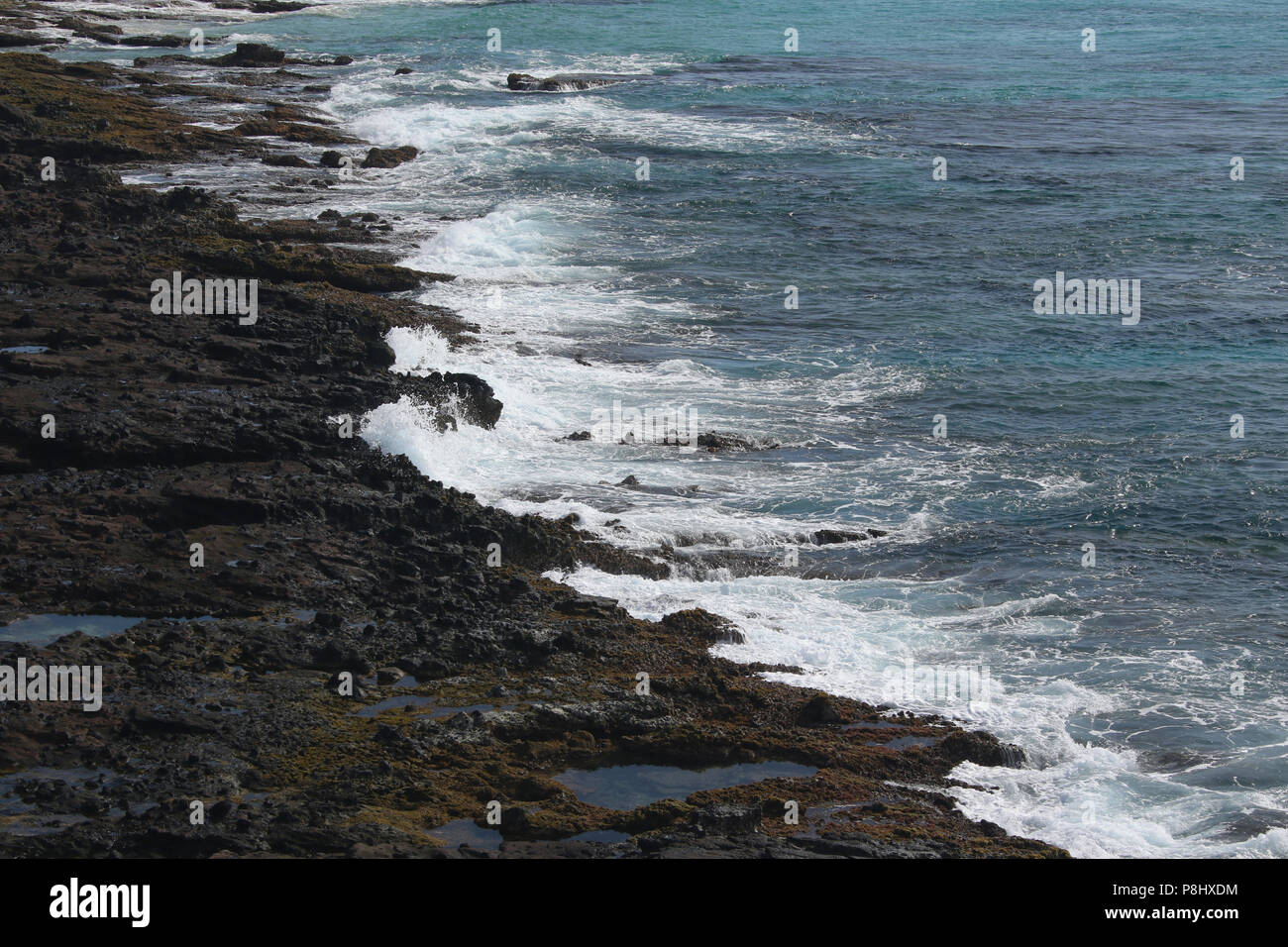 Volcanic rock shoreline as viewed from the Halona Hole Lookout. Oahu ...