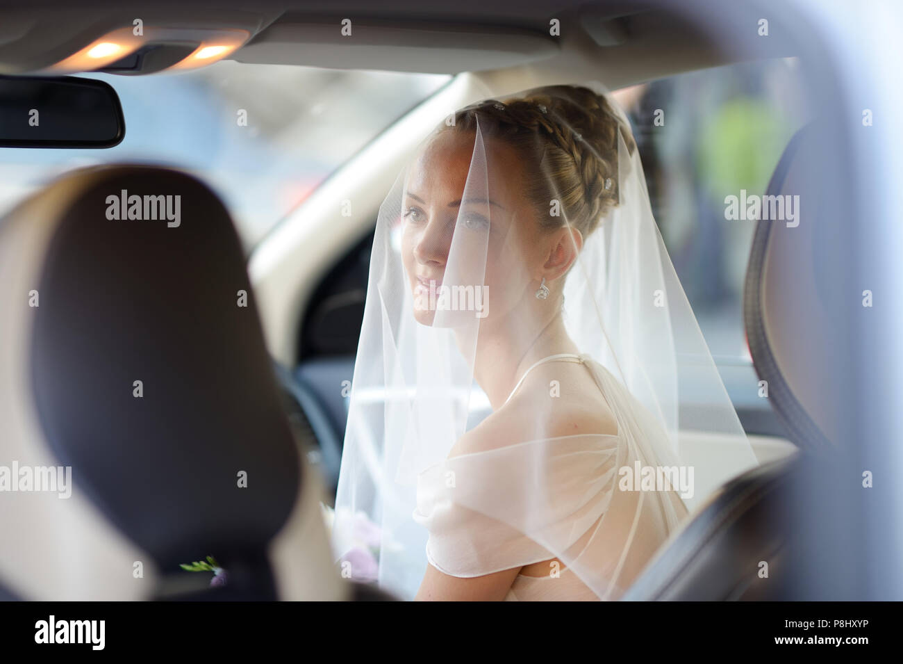 Beautiful young bride portrait in a wedding car Stock Photo - Alamy