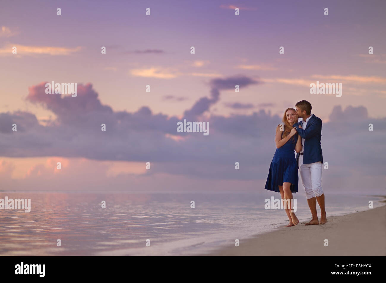 Beautiful romantic couple on a sunset on tropical beach Stock Photo - Alamy