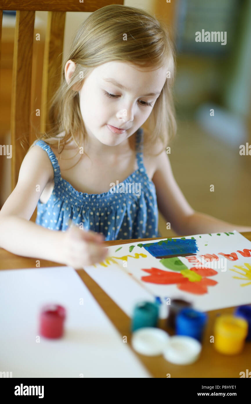 Cute little girl is drawing with paints in preschool Stock Photo - Alamy