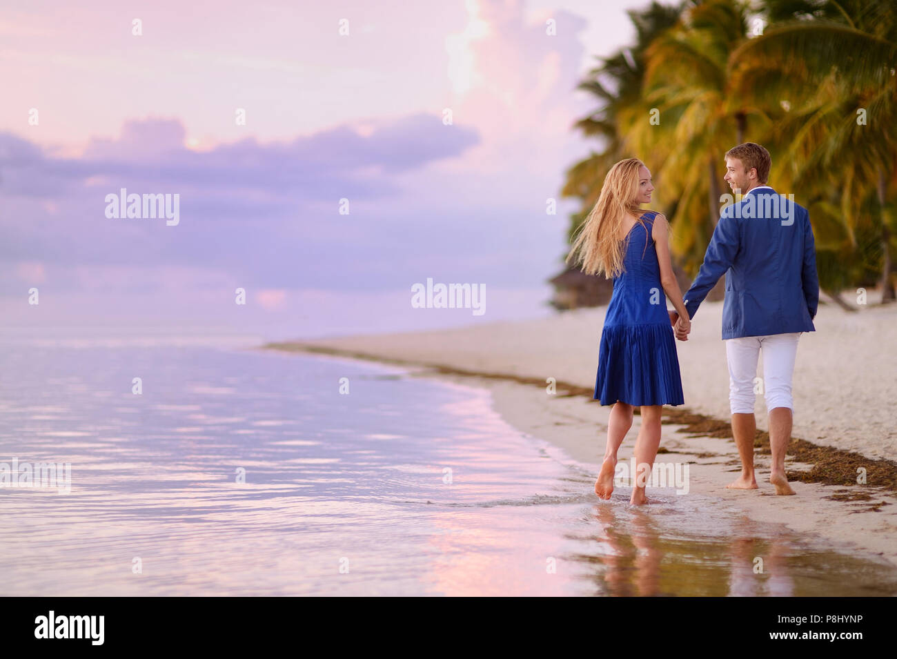 Beautiful romantic couple on a sunset on tropical beach Stock Photo - Alamy