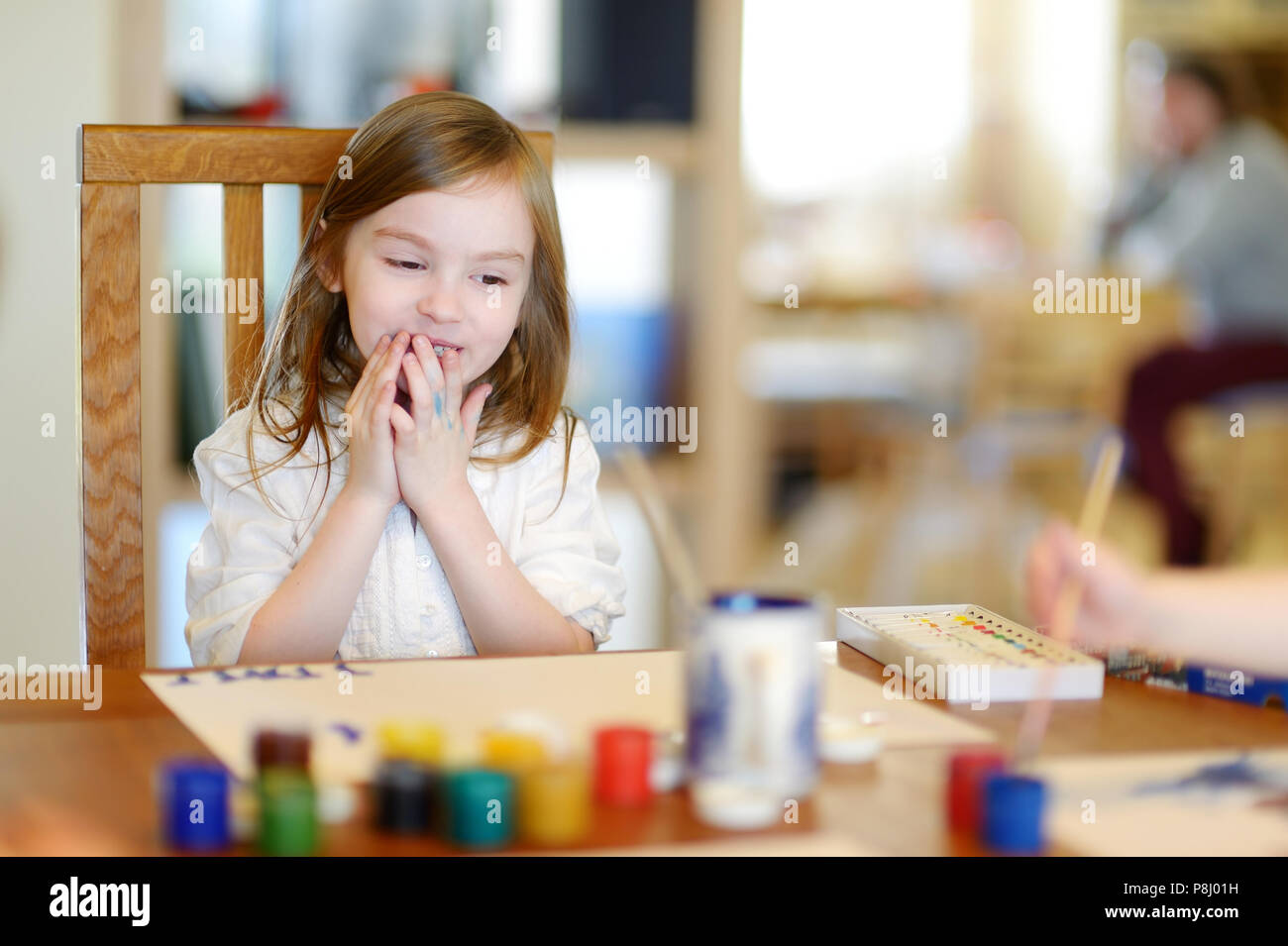 Cute little girl is drawing with paints in preschool Stock Photo - Alamy